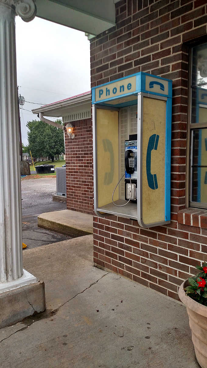 A payphone on the wall - not a retro design choice, but an authentic artifact from when restaurants were social hubs.