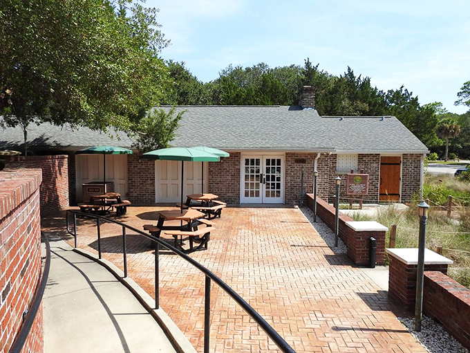 This brick patio has hosted countless picnics and family gatherings. The umbrellas aren't just decorative&mdash;they're essential Florida survival gear.