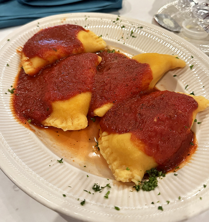These ravioli swimming in rich tomato sauce aren't just pasta &ndash; they're edible time machines transporting you to Sunday dinners at Nonna's house.
