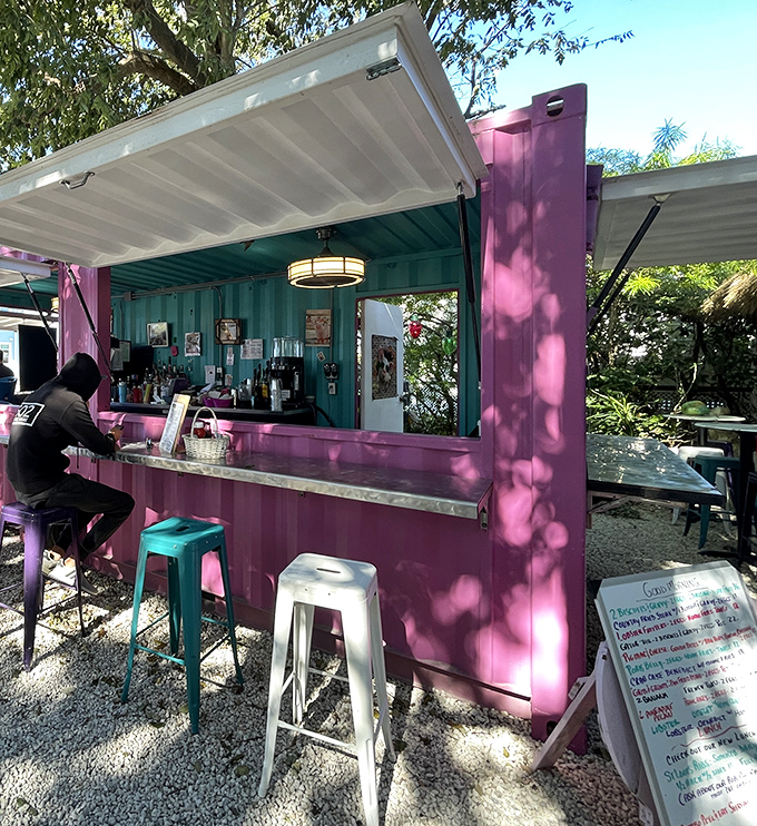 The outdoor bar glows pink in the Florida sunshine, a tropical oasis where mimosas flow and vacation mode is permanently activated.