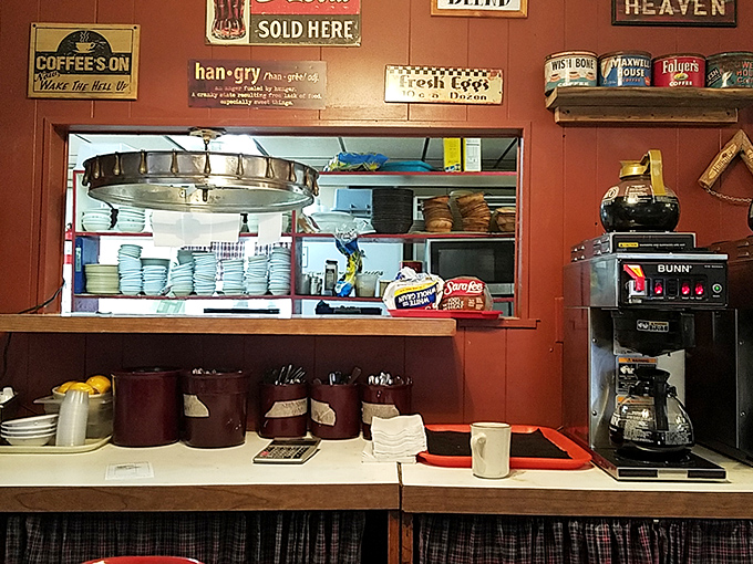 The kitchen pass reveals the beating heart of the operation&mdash;stacked plates ready for action and a coffee maker that never gets a day off. Americana in its natural habitat.