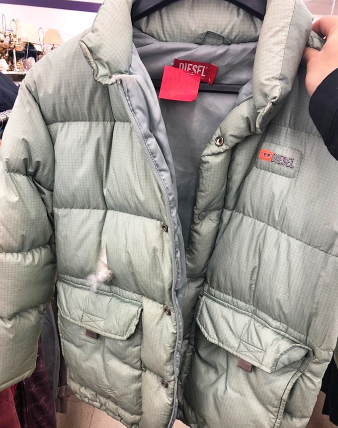 A Diesel puffer jacket hangs patiently, its previous life in some fashionable closet now giving way to new adventures.