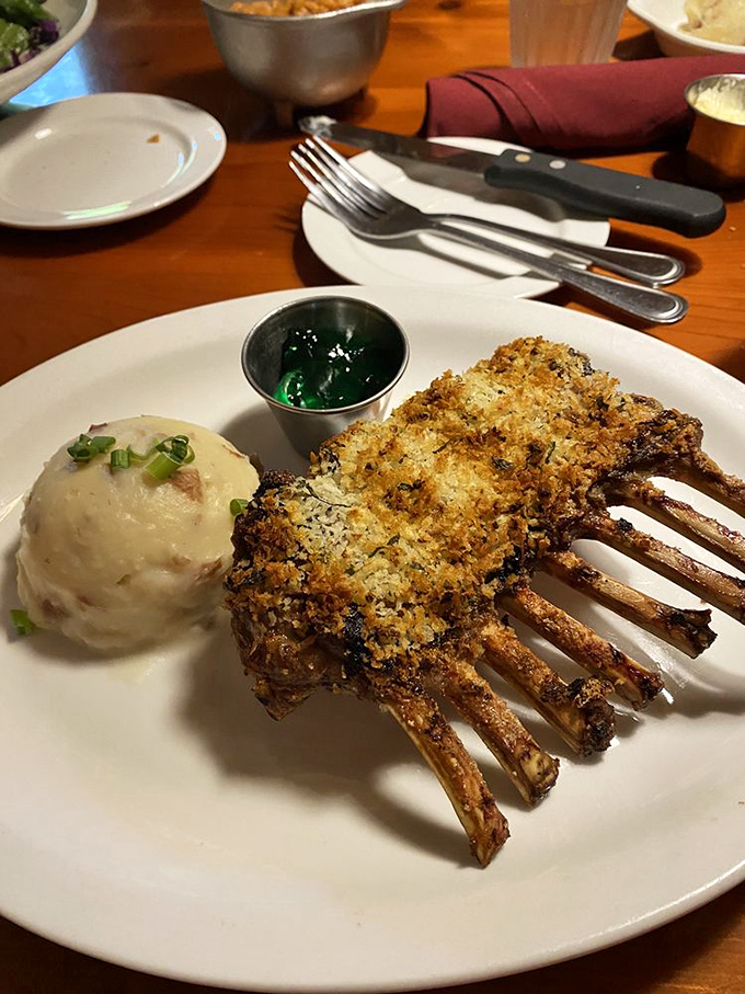 Rack of lamb wearing a crispy herb crust like it's dressed for the meat prom. That mint jelly is its corsage.