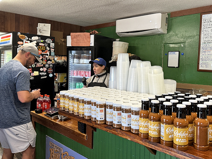 Behind that counter, barbecue sauce bottles stand ready like soldiers awaiting their delicious mission.