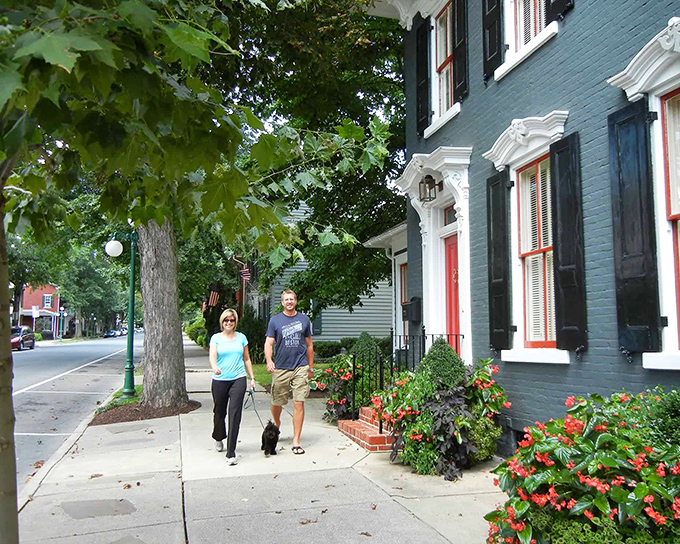 Residents stroll along flower-lined sidewalks where neighbors still wave and dogs receive more greetings than celebrities in Los Angeles.
