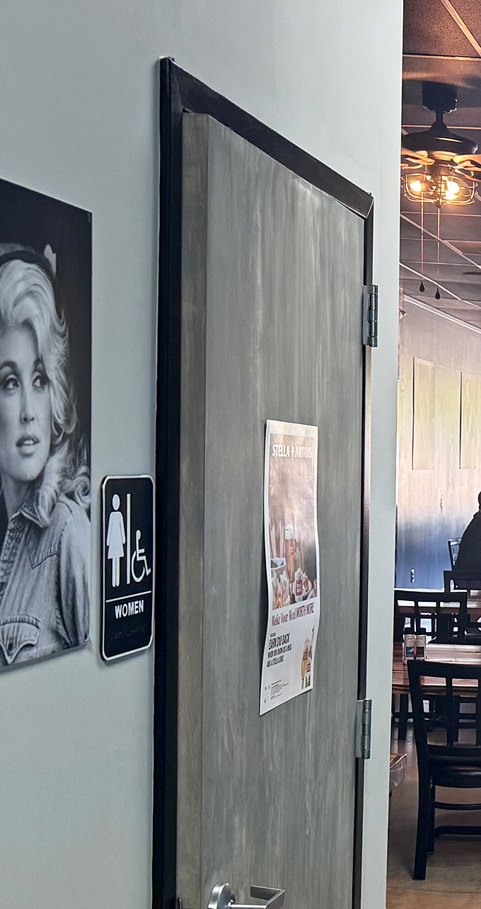 Even the restroom entrance shows attention to detail with classic photography that continues the restaurant's stylish aesthetic throughout.