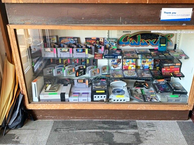 The video game cabinet: where Gen X nostalgia meets millennial collecting frenzy in a glass case of Nintendo cartridges and forgotten consoles.