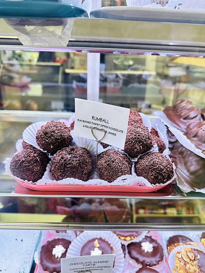 Rum balls rolled in chocolate sprinkles – proof that adults deserve treats too, with just enough kick to remind you these aren't your kid's desserts.