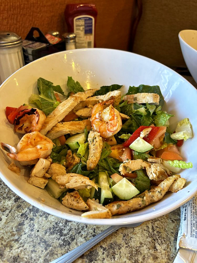 A salad that doesn't apologize for being healthy. Those grilled shrimp and chicken strips are playing the long game against your hunger.