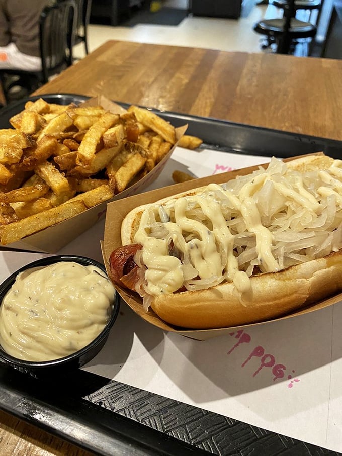 The Sauerkraut Dog with a side of creamy sauce is what happens when German tradition meets American ingenuity. A tangy, savory masterpiece.