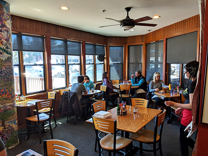 The dining room where strangers become temporary neighbors, united by the universal language of "mmm" and "pass the syrup, please." 