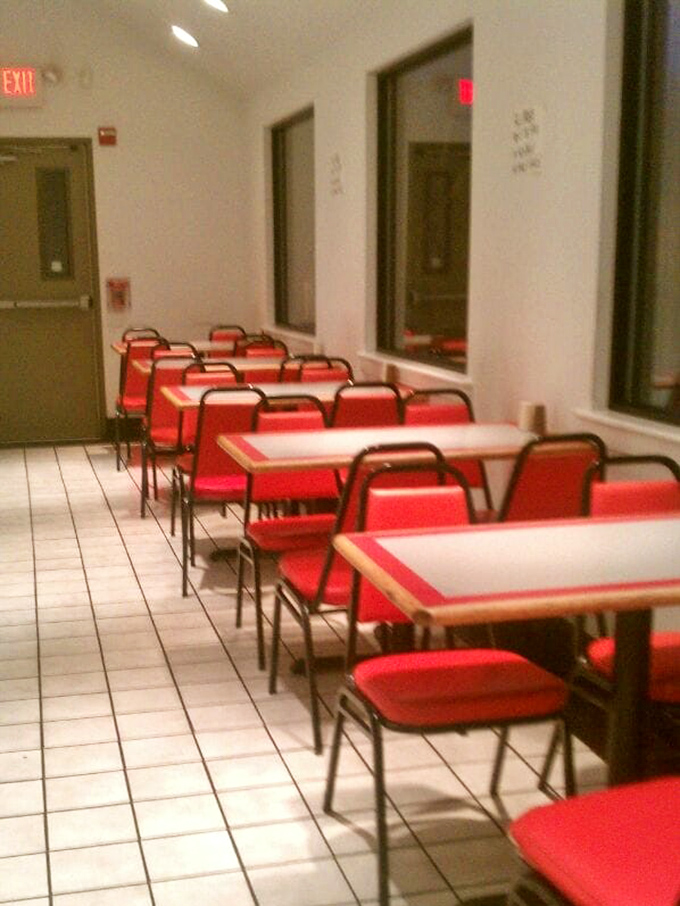 Red chairs await sandwich pilgrims in this spartan dining area. No distractions from the serious business of hoagie appreciation happening here.