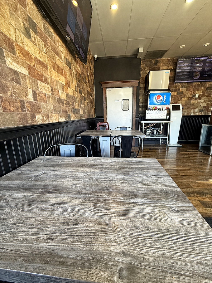 Weathered wooden tables have witnessed countless burger victories and satisfied sighs over the years.