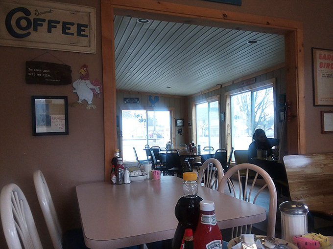 Sunlight streams through windows illuminating simple tables where farmers sit alongside office workers&mdash;breakfast democracy in its purest form.