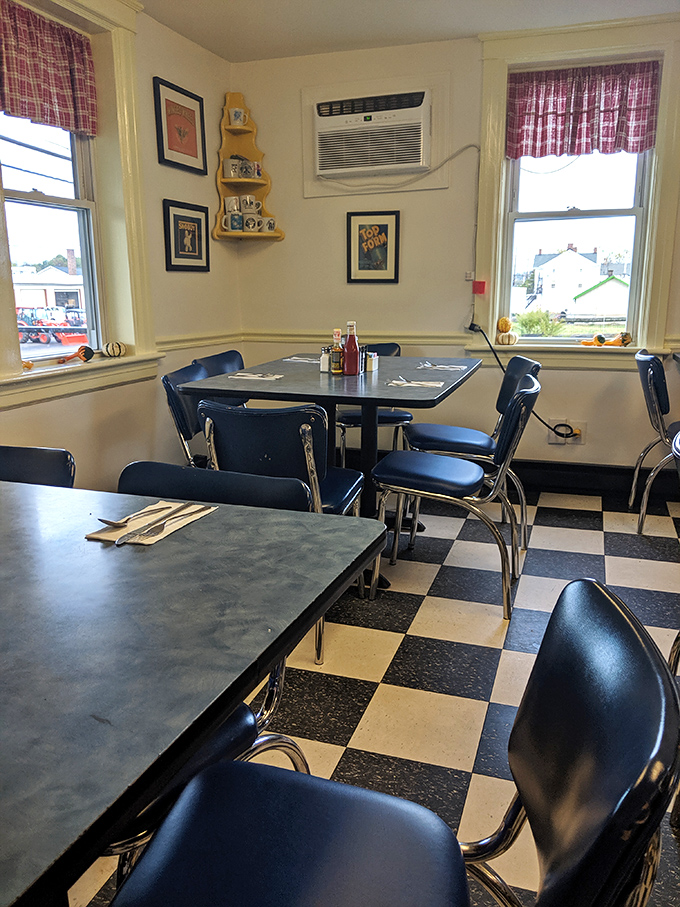 The corner table&mdash;prime diner real estate. Those plaid curtains and checkered floor have witnessed more local gossip than a small-town newspaper.