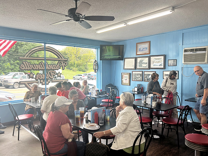 Sunlight streams through windows as diners gather at tables &ndash; this isn't just eating, it's the daily ritual of small-town connection.