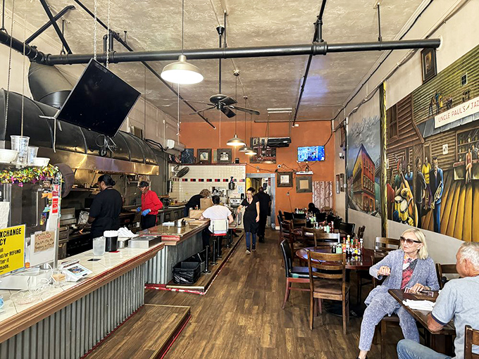 The dining room hums with the satisfied murmurs of regulars and first-timers alike. Orange walls radiate warmth that matches the food.