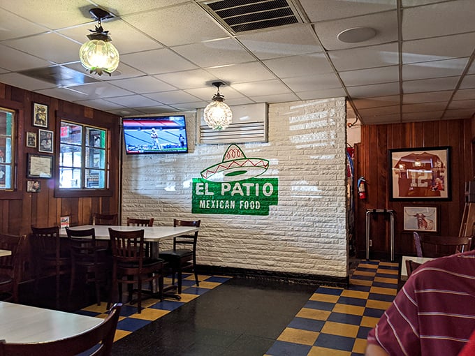 The white brick wall proudly displays the El Patio logo&mdash;a simple reminder that you're in a place that understood Tex-Mex before it was cool.