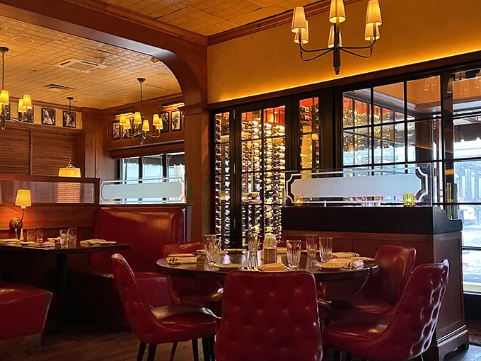 Wine bottles visible through glass partitions remind you that great steak deserves equally distinguished liquid companions.