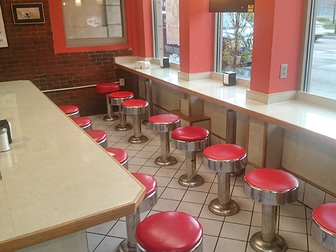 Diner seating that invites both solitude and conversation. These classic red stools have supported the weight of countless life decisions, both good and questionable.