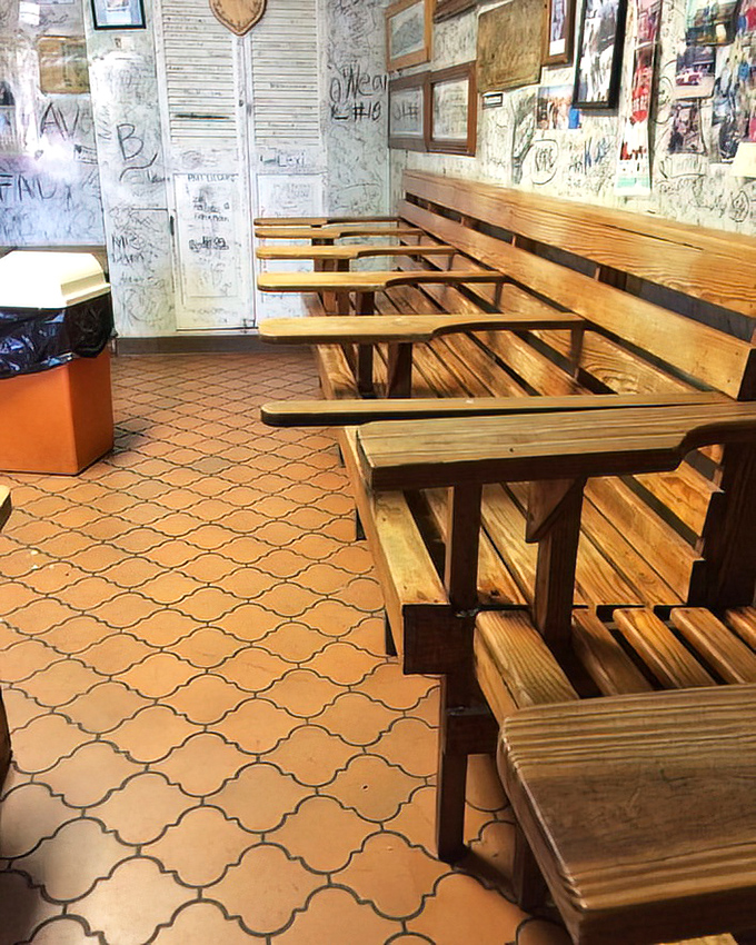 The dining area's wooden benches and graffiti-covered walls tell stories of visitors past&mdash;each signature a testament to burgers worth remembering.