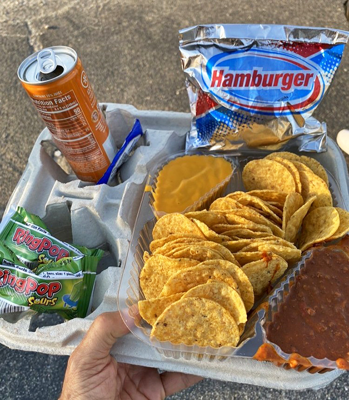 The ultimate drive-in feast: nachos, cheese, Ring Pops, and a cold drink. No movie experience is complete without proper snacking strategy.