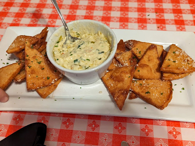 Golden fried ravioli triangles huddled around creamy dip like campfire scouts sharing the world's best secret.