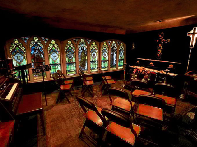The chapel room's stained glass casts eerie colored light across empty chairs—Sunday service for those who've crossed to the other side.