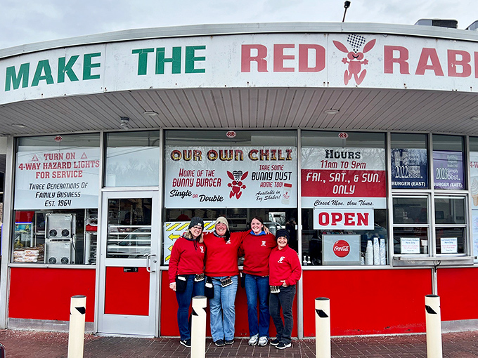 The iconic Red Rabbit crew stands proudly before their time capsule of American cuisine. Their red uniforms practically scream "We take fun seriously!"