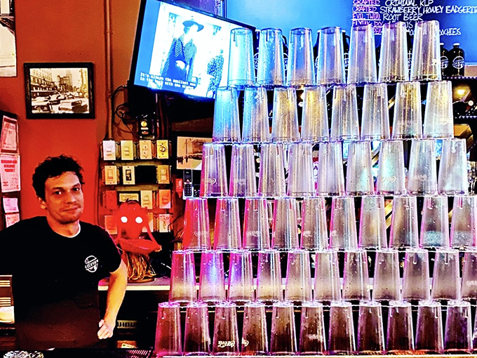 Stacking glasses with the precision of a Jenga master, this bartender knows the structural engineering behind proper glassware architecture.