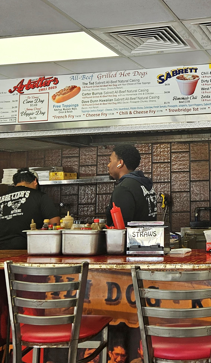 Where the hot dog magic happens&mdash;skilled hands prepare each order with the efficiency that comes only from years of practice.