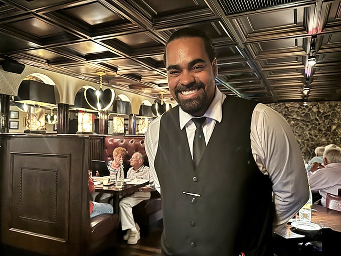 The smile says it all&mdash;service with genuine warmth rather than corporate-mandated cheer. A true hospitality professional.