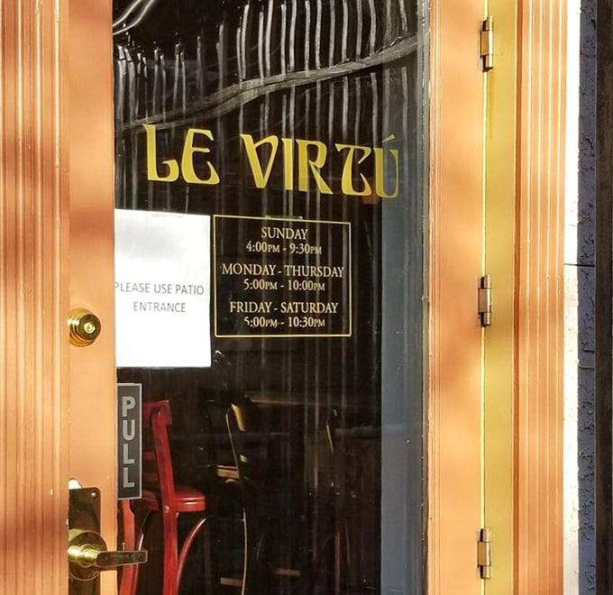 The door promises specific hours but the experience inside promises timelessness. That golden glow beckons like a lighthouse for hungry souls.