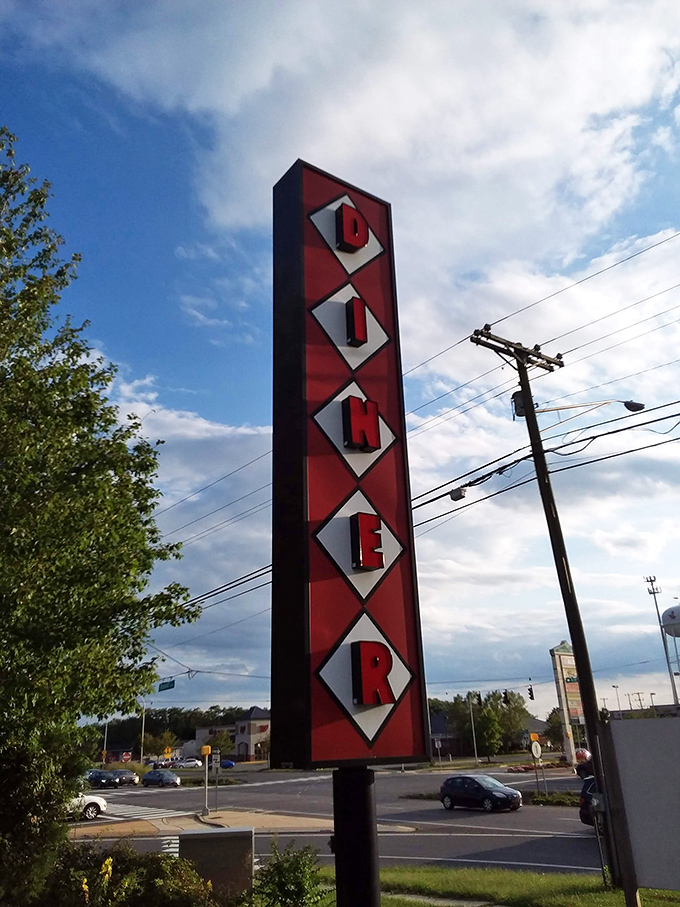 The vertical "DINER" sign stands tall against the Delaware sky, a red and white monument to hunger satisfaction.