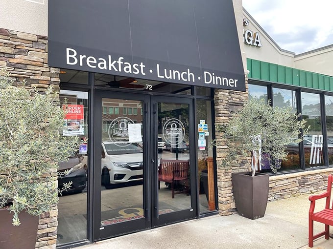 Breakfast • Lunch • Dinner promises all-day delights behind those doors. The stone façade adds a touch of rustic elegance.