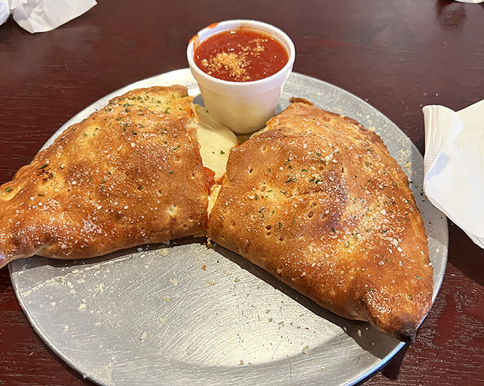 Golden-brown, perfectly baked stromboli with marinara for dipping &ndash; a handheld feast that somehow improves on the already perfect pizza concept.