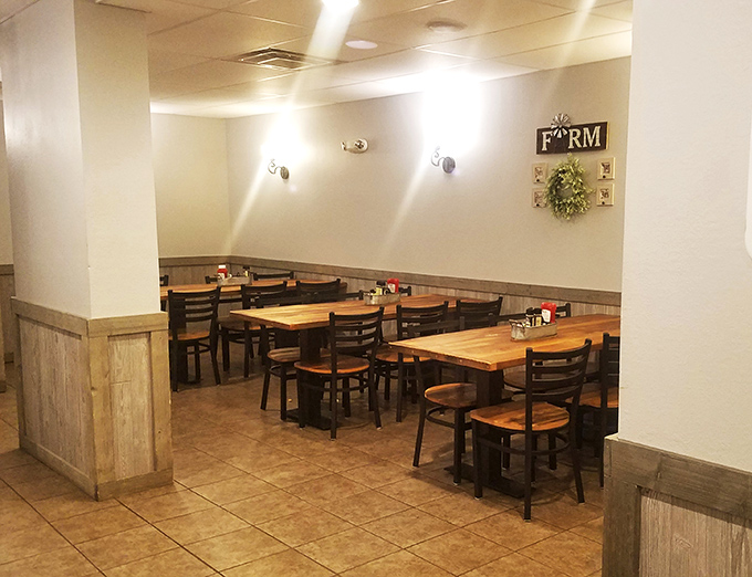 The quieter dining section, where wood-paneled walls and simple farm decor create the perfect backdrop for serious eating business.
