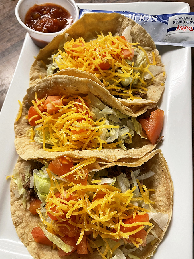 Tacos that don't care what time of day it is, loaded with fresh veggies and cheese that cascades like a yellow waterfall.