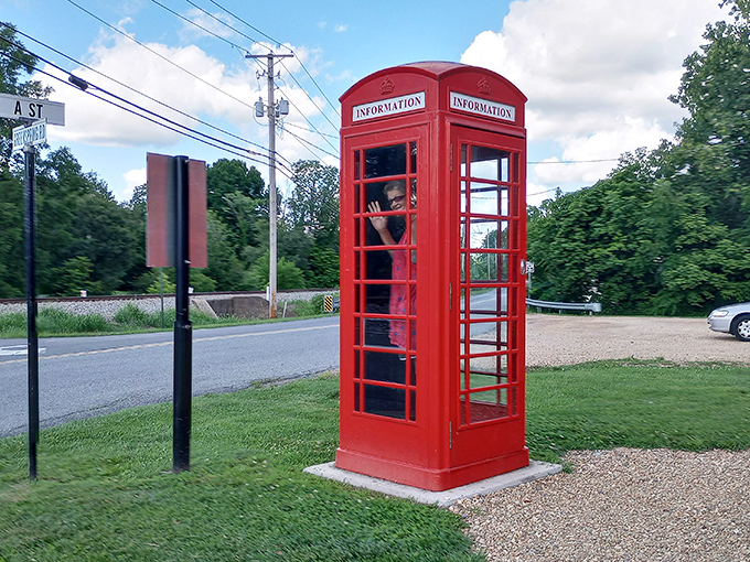 A classic telephone booth stands as a charming reminder of when conversations required actual commitment and quarters.