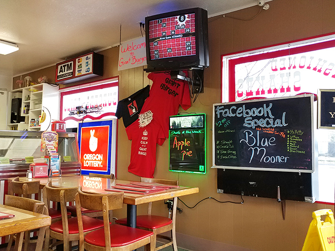 The wall of fame: Giant Burger merchandise, lottery tickets, and specials board create the authentic diner atmosphere no designer could replicate.