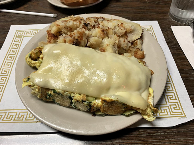 This isn't just an omelet—it's a cheese-blanketed masterpiece hiding a garden of vegetables. The kind of breakfast that makes vegetables actually exciting.
