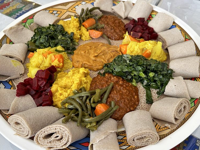 The vegetarian combo proves meat-free doesn't mean flavor-free, with each colorful dollop offering a different plant-based pathway to satisfaction.