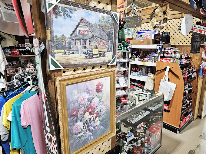 Vintage Coca-Cola signs and floral paintings create a slice of Americana. This booth perfectly captures that nostalgic small-town general store feeling that's increasingly hard to find.