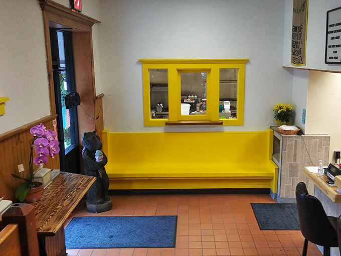 The cheerful yellow entryway&mdash;like stepping into breakfast sunshine. Even the bear statue looks happy to be here.