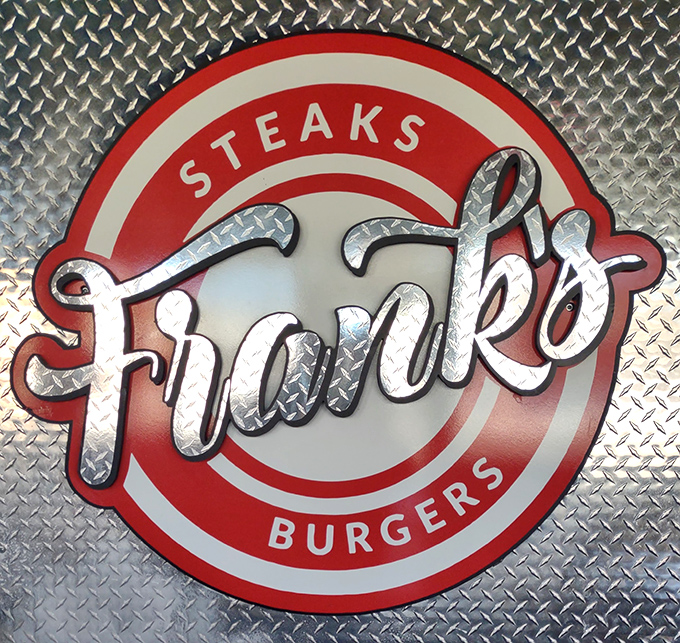 The logo gleams against diamond plate metal&mdash;industrial chic that says, "We're too busy making great food to worry about interior design trends."