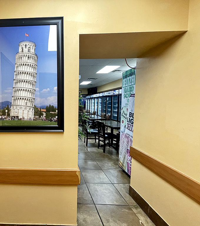 A framed Leaning Tower of Pisa watches over the entrance to the dining area&mdash;a nod to Italian heritage in this Pittsburgh pizza paradise.