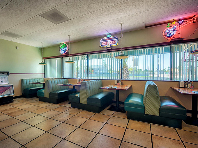 Vintage charm meets modern comfort in these mint-green booths, where neon signs cast a warm glow over countless Phoenix breakfast stories.