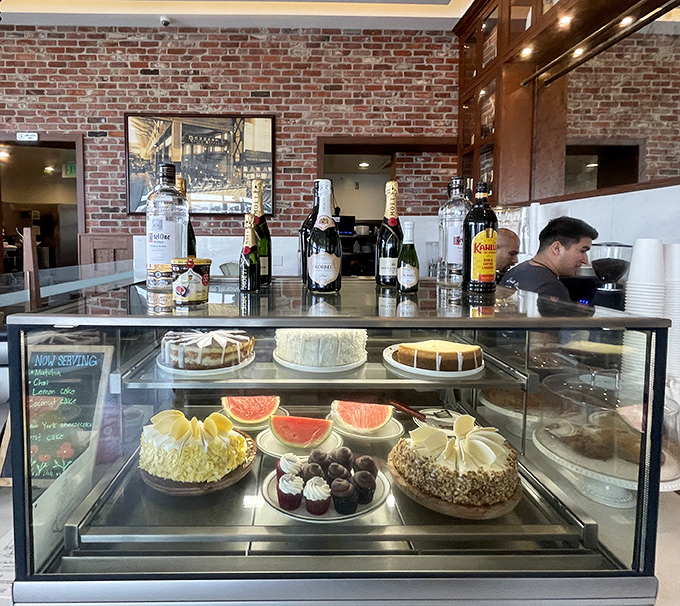 The dessert case: where willpower goes to die. Fresh fruit and decadent cakes stand guard behind glass, daring you to save room.