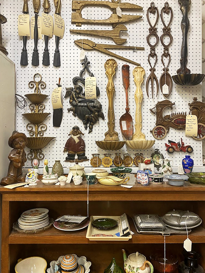 Ornate serving utensils and decorative wall pieces hang like metallic artwork—functional history waiting to add character to contemporary kitchens.