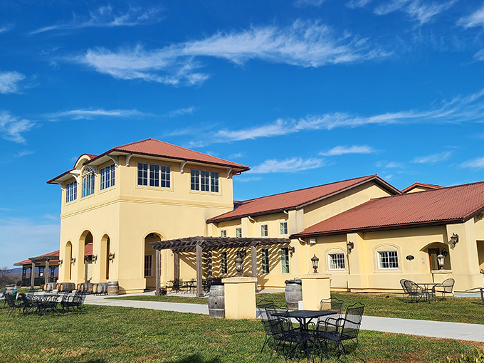 Mediterranean-style architecture at Breaux Vineyards invites you to relax on the patio under expansive blue skies and wispy white clouds.